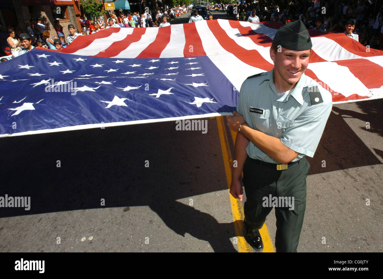 Jessy Touchstone 16, of Concord, Calif., carries a large flag with ...