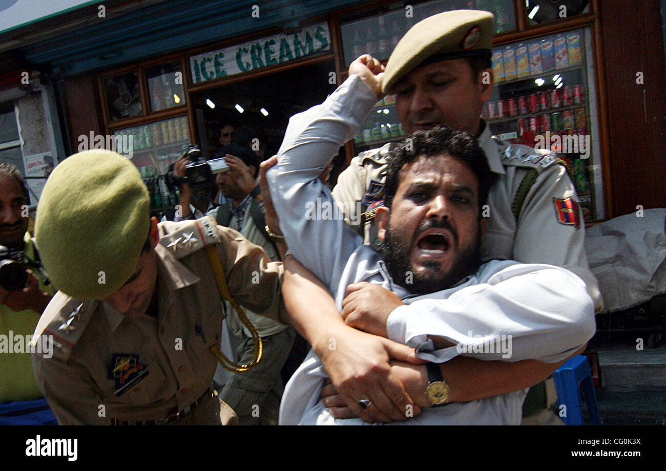 Indian police detain an activist from the All Party Hurriyat (Freedom ...