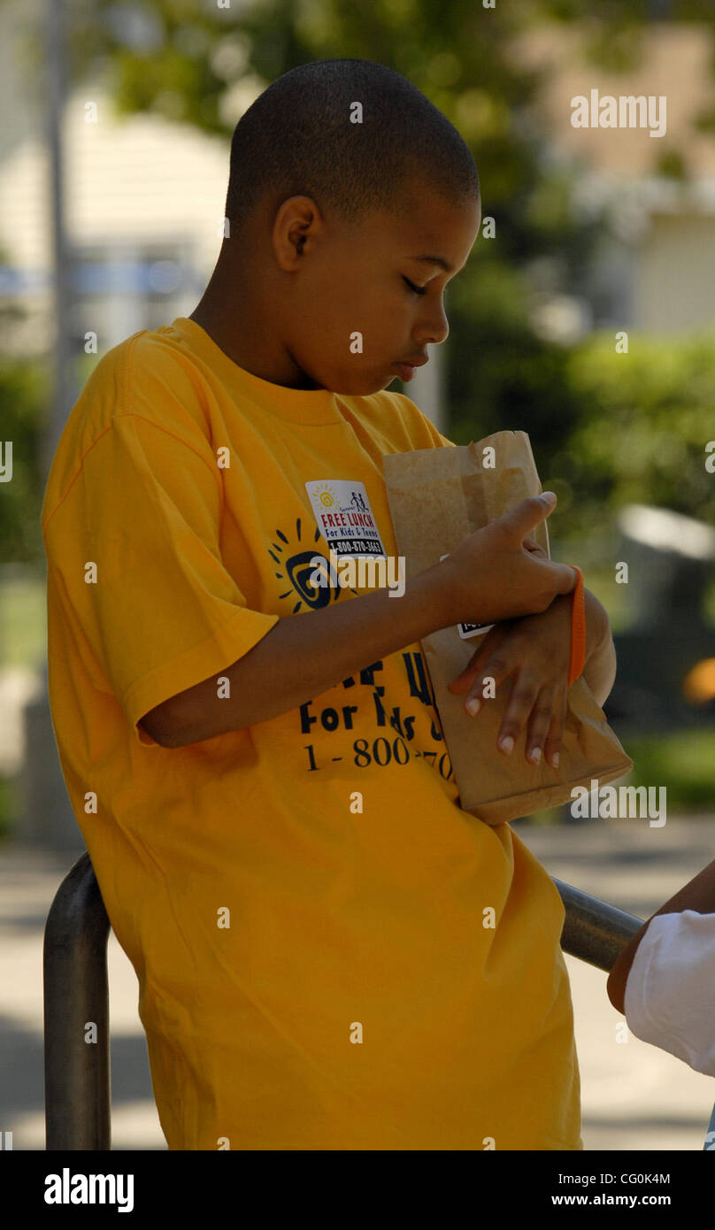 Omari Scott, 11, looks through his goody bag of a small football ...