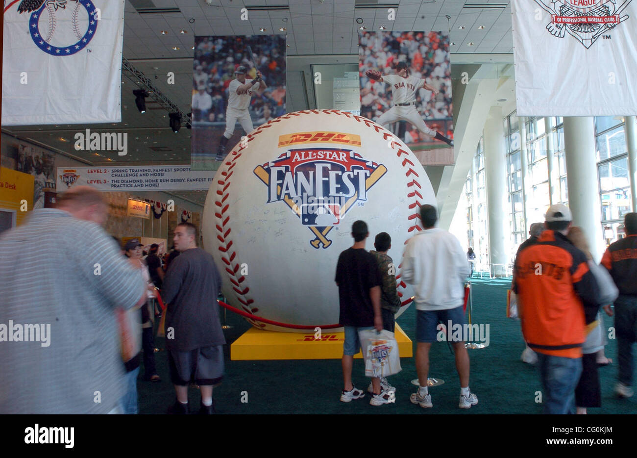 Fans pass the huge baseball as they enter Fanfest during the Fanfest ...