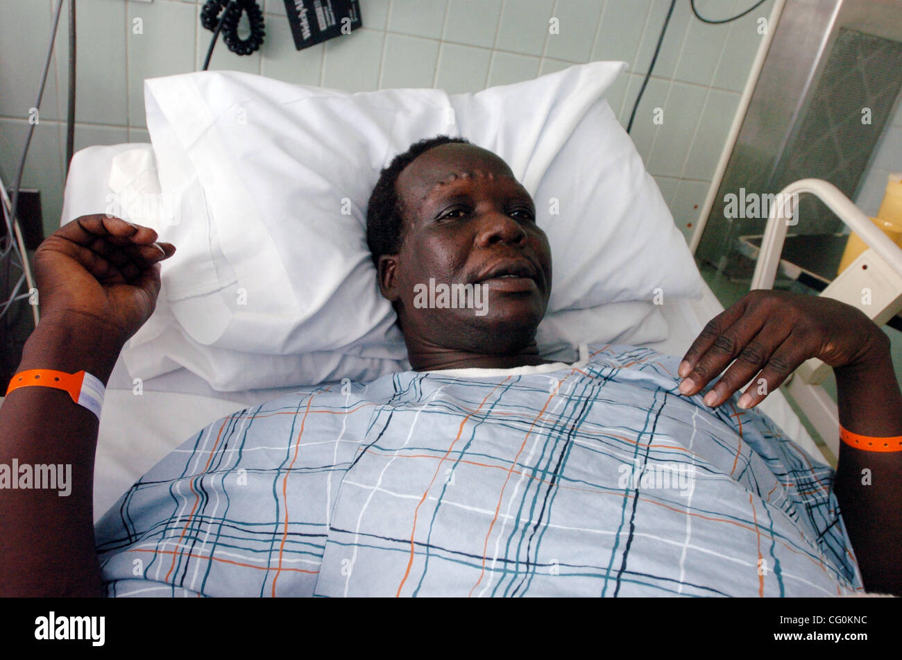 Simon Deng, 47, of Manhattan lies in a hospital bed at Harlem Hospital ...