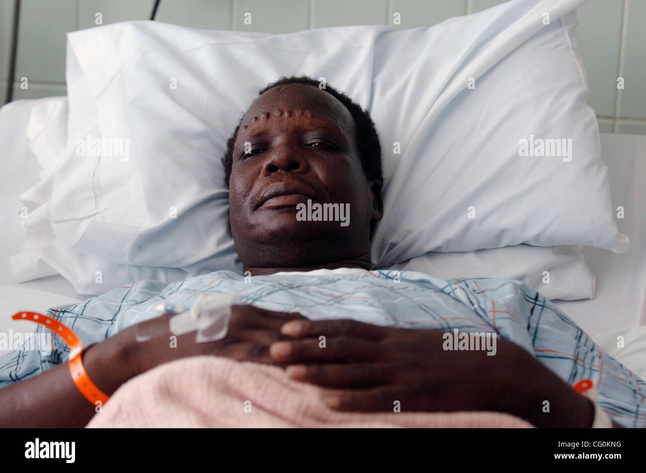 Simon Deng, 47, of Manhattan lies in a hospital bed at Harlem Hospital ...