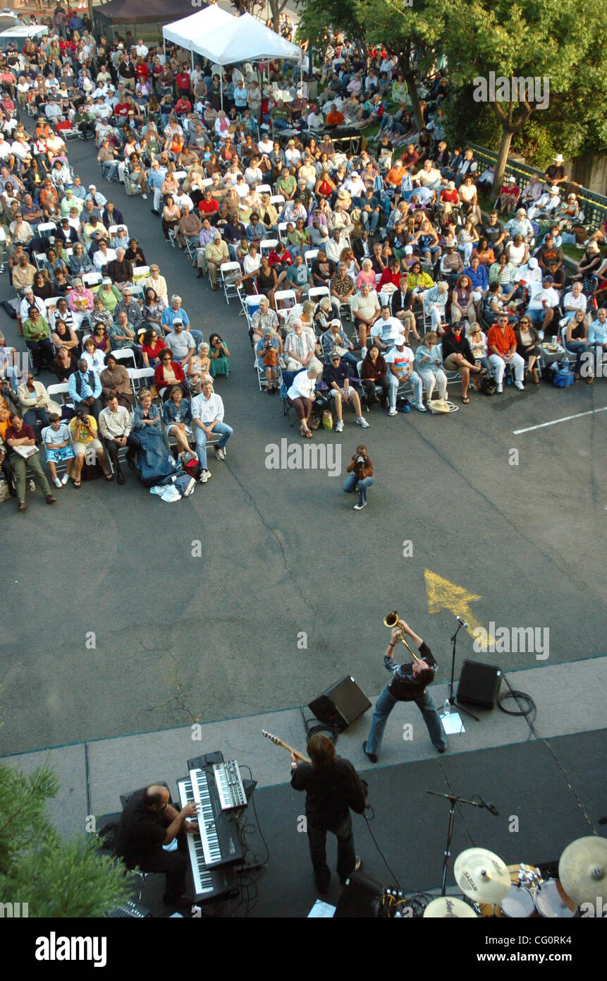 Steve Cole performs a song for a large crowd during a free jazz concert ...