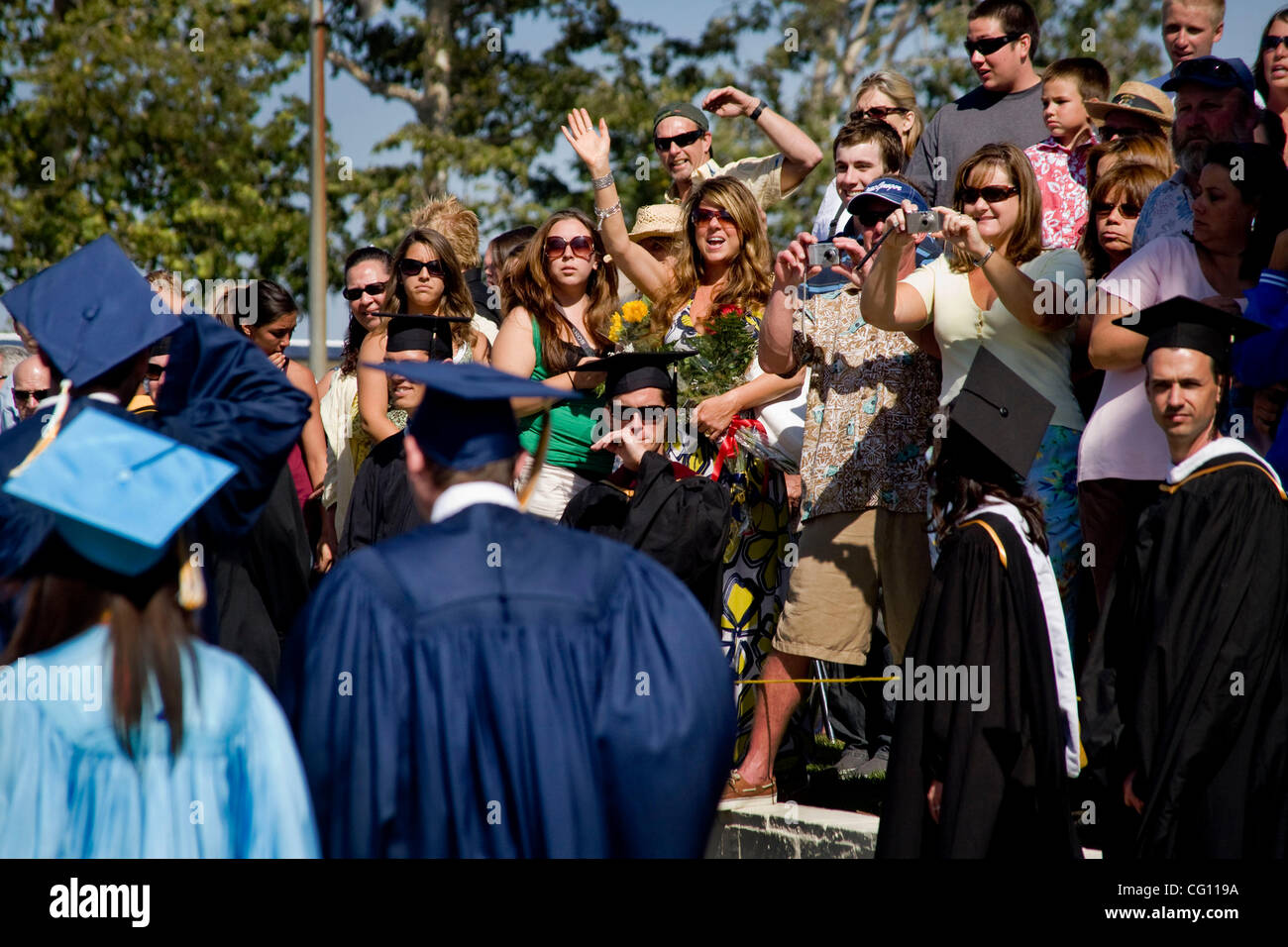 Proud high school seniors march past well wishers during graduation ...