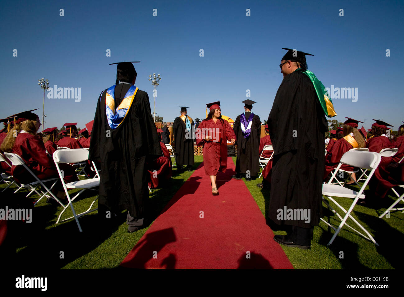Carrying her new diploma, a proud Hispanic high school senior marches ...