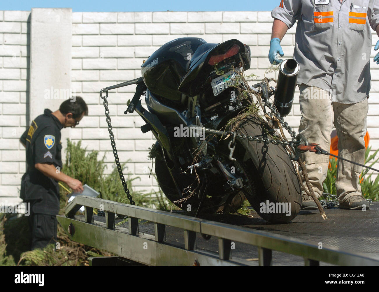 A wrecked motorcycle is being towed away after a fatal accident in ...