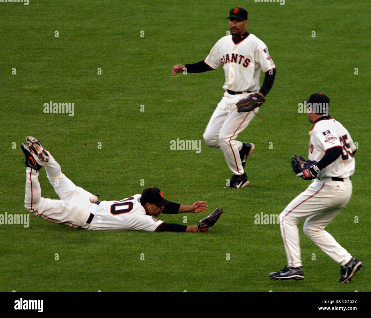 Dave Roberts (#10)(left) of the San Francisco Giants cannot come up ...