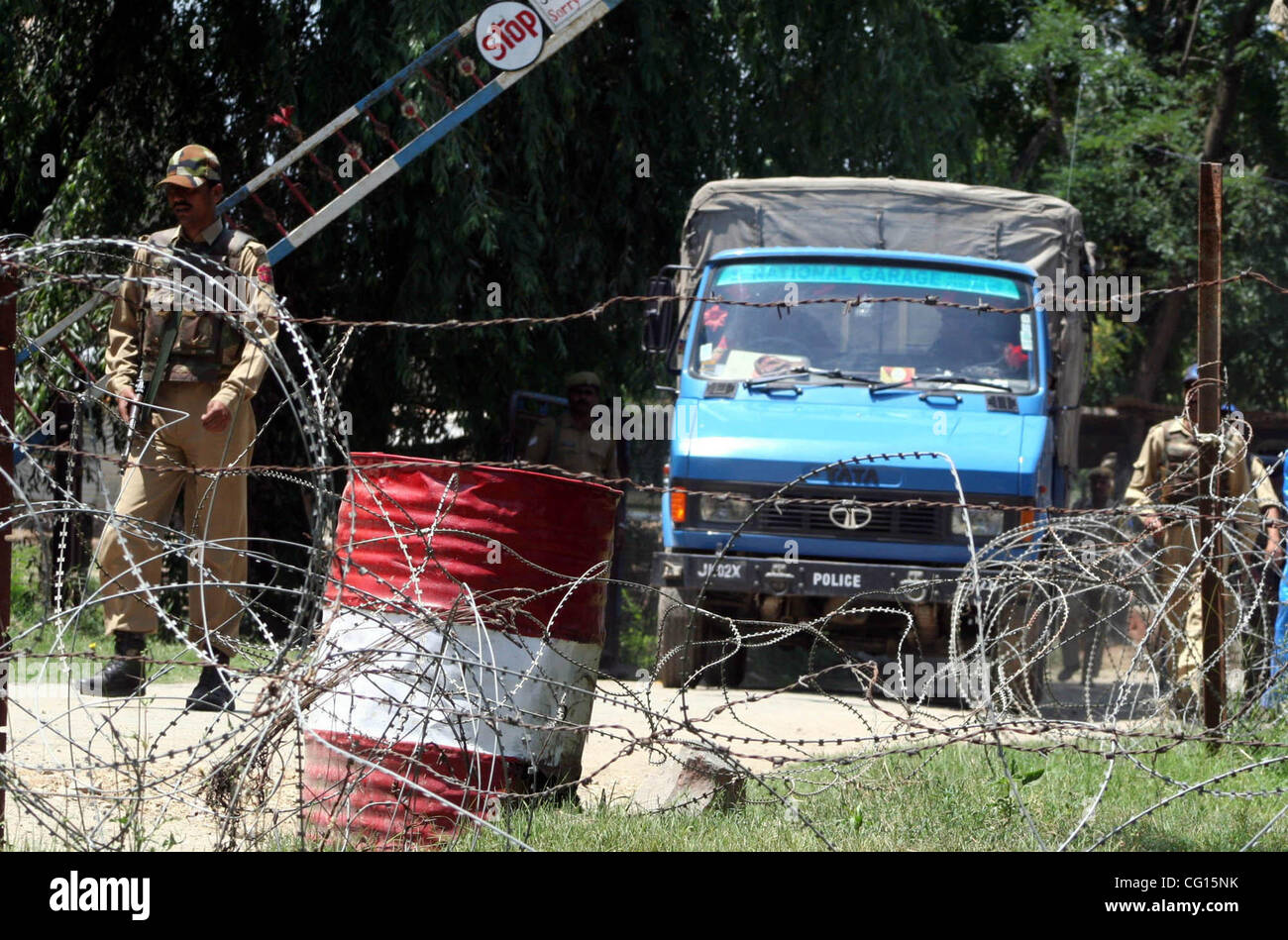 Indian paramilitary soldiers place barricades at the entrance of their ...