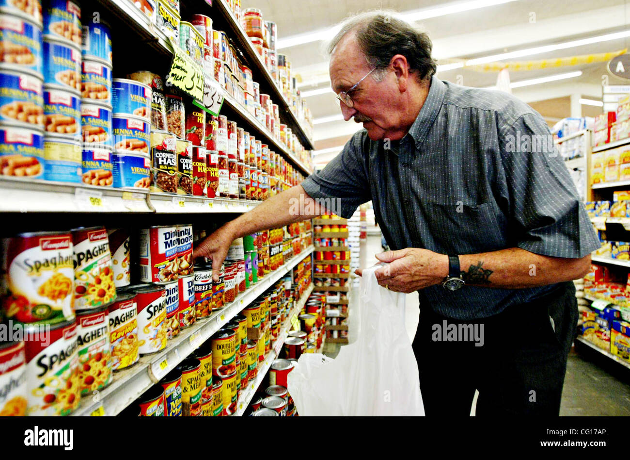 Store Manager Bill McClendon pulls 15 oz. cans of Castleberry's Beef ...