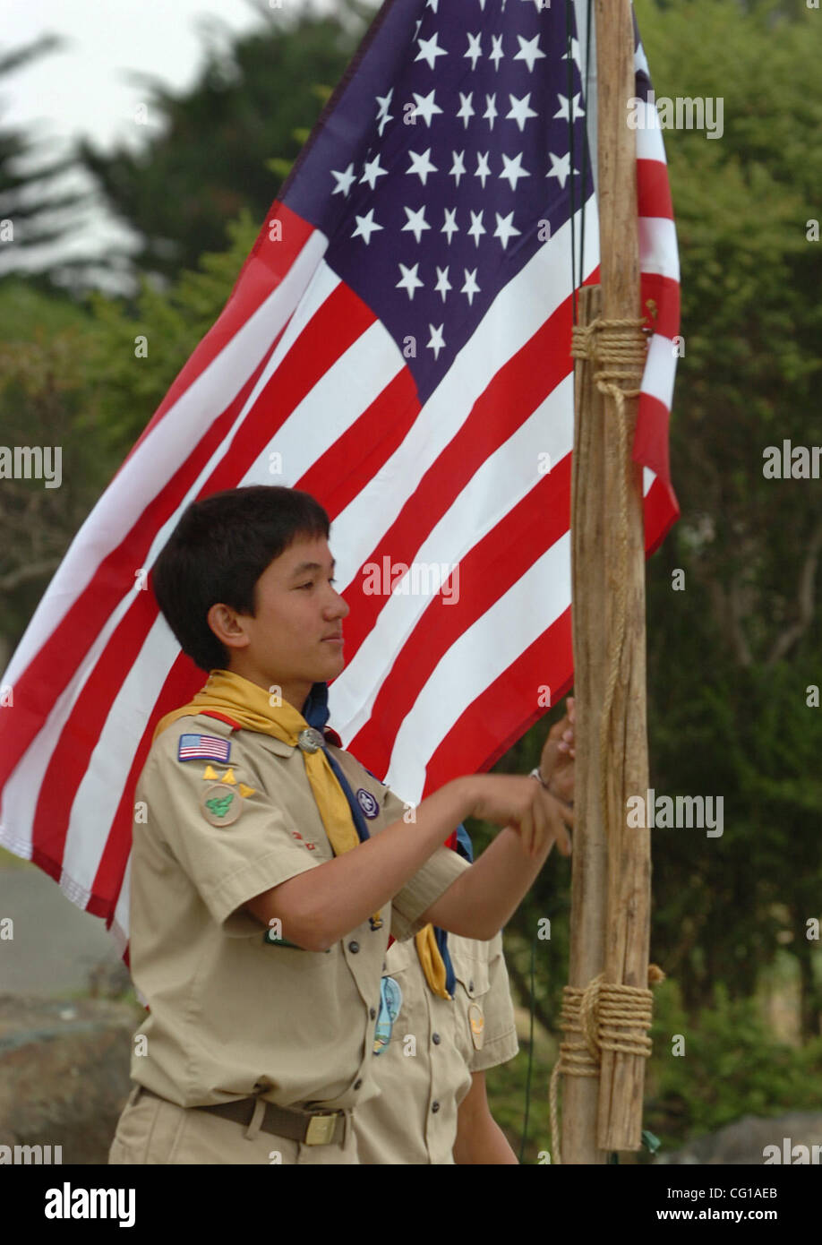 Scout Ian Farnkopf from troop 6 in Berkeley raises the flag during a ...