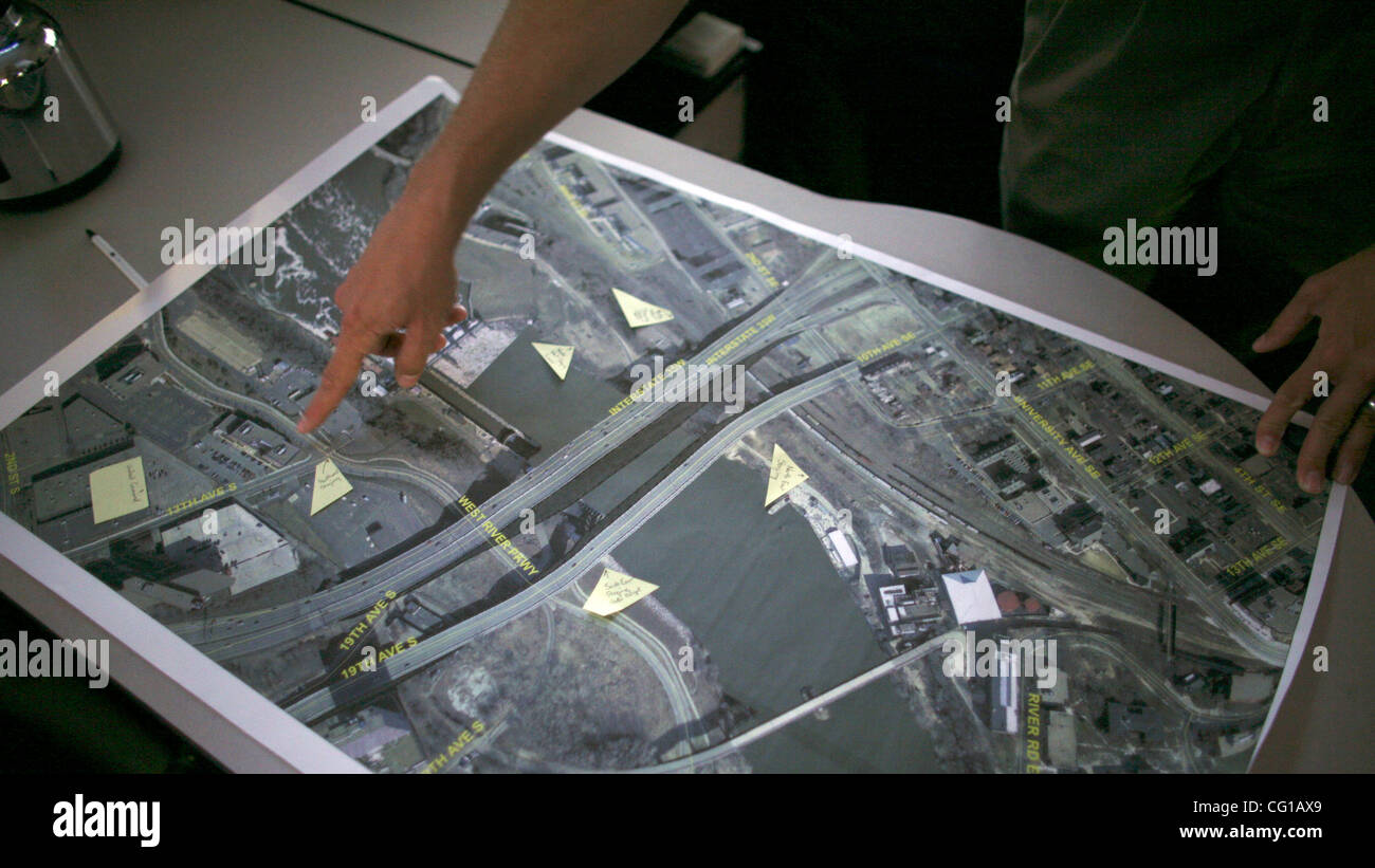 Dr. John Hick pointing to a satellite image of the bridge that ...