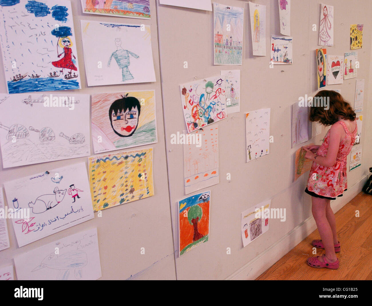 Kate Dunn, 8, picks a piece of refugee artwork to reply to at MOCHA ...