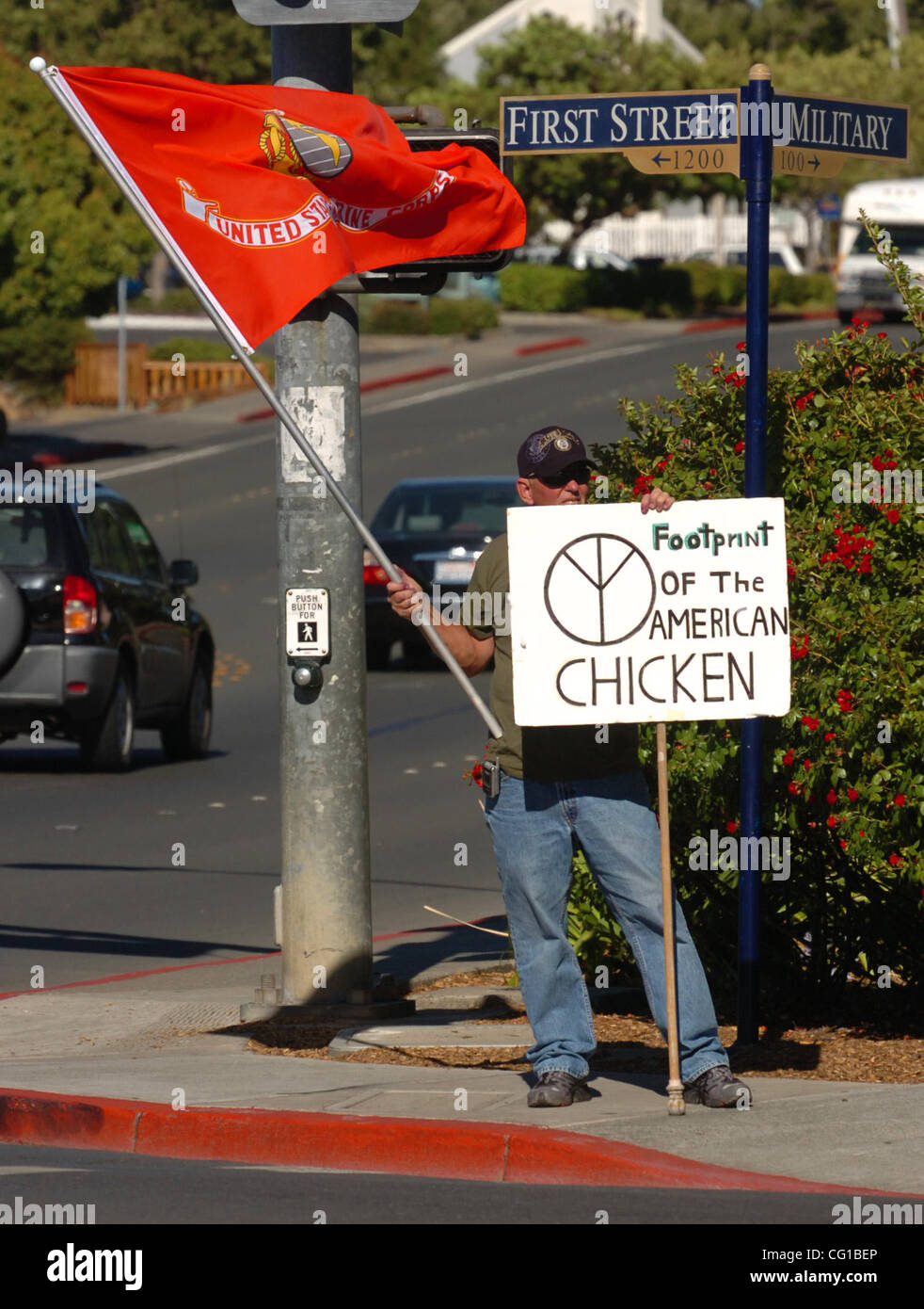 War supporter Paul Dismuke, from Benicia, holds the U.S. Marines flag ...