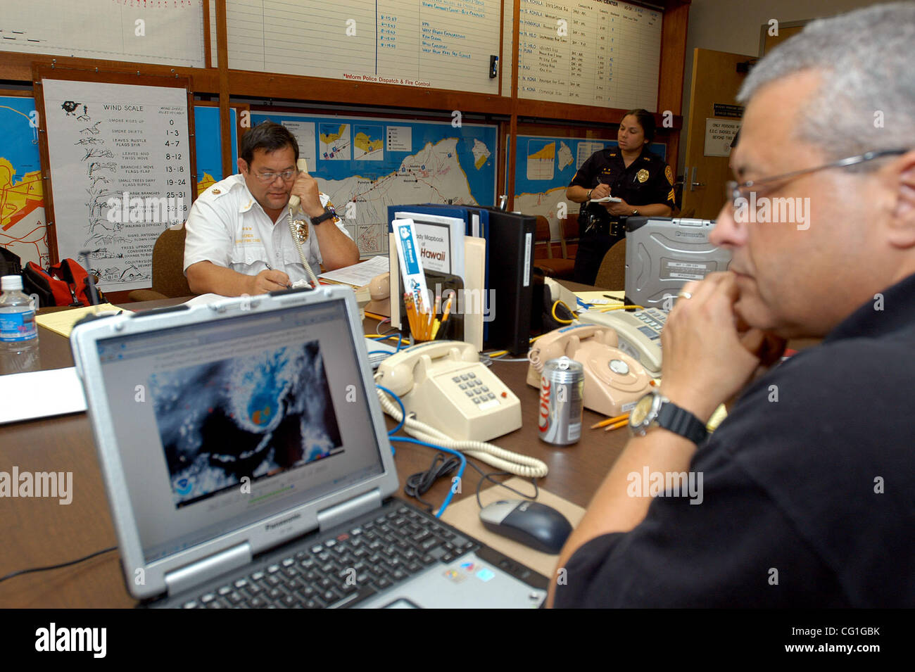 (right) Hawaiian Police officer Tabares watches on the movement of ...