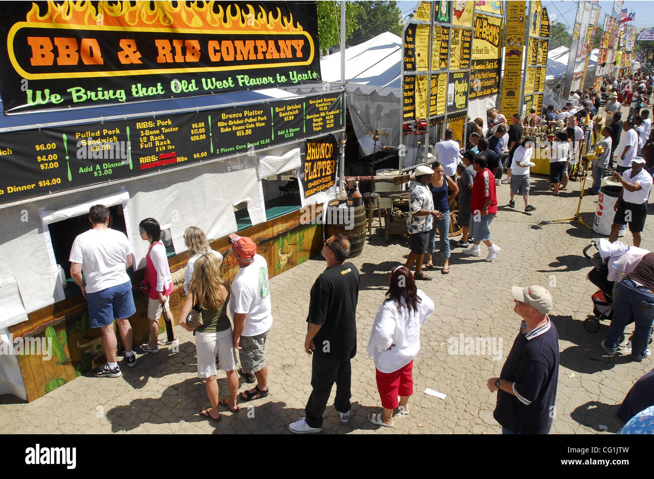 People attending the Bay Area Barbeque Cook Off wait in line for some ...