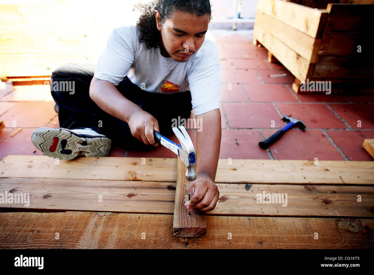 Martin Rochin, 16, of San Jose, helps build a rooftop garden at EC ...