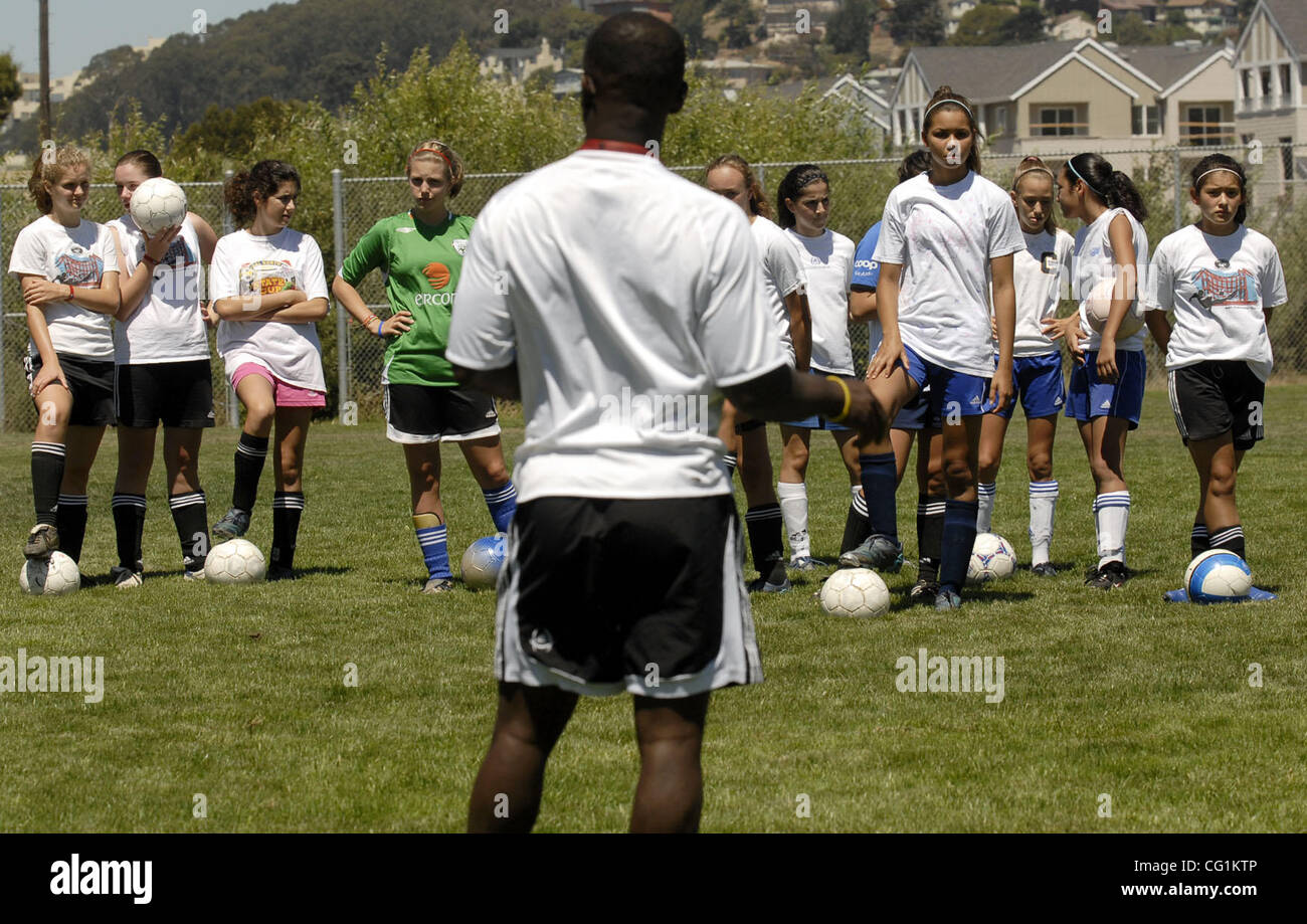 The Mavericks under 14 girls team listen to coach Robert Sackey as he ...