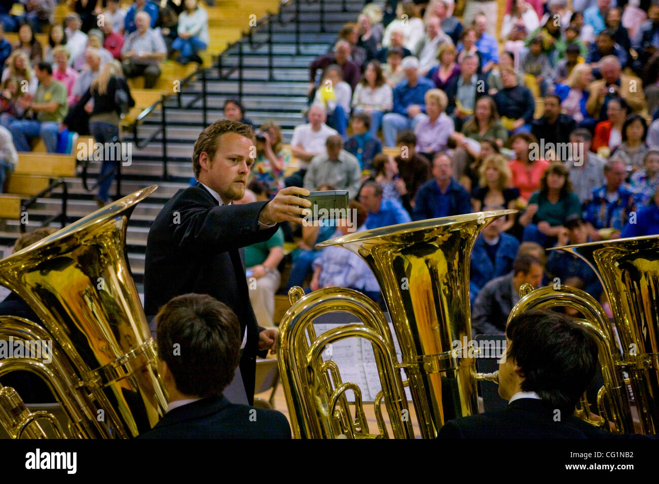 Using an electronic pitch-checker, a conductor verifies his musicians ...