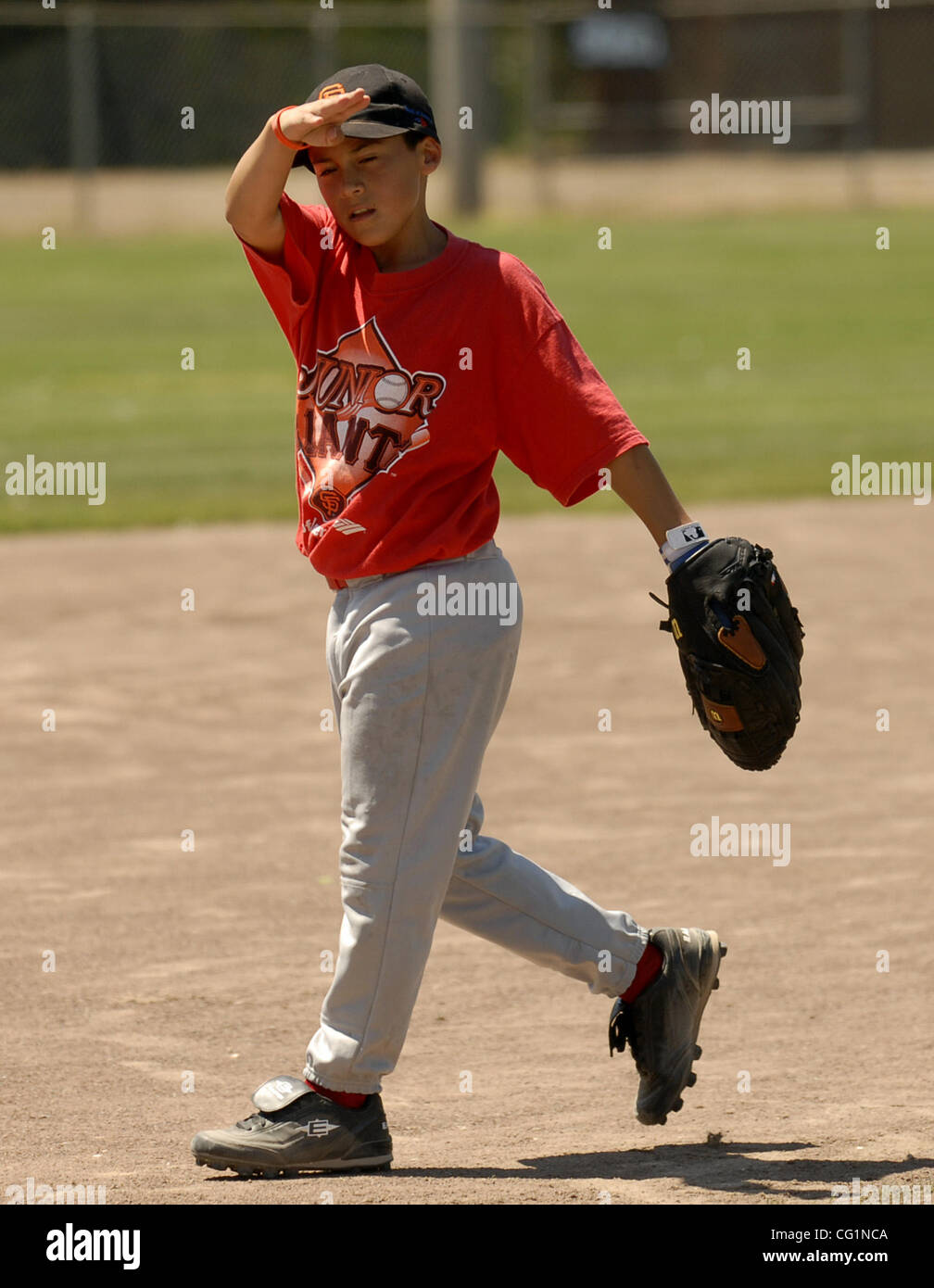 Alex Romo, 12, salutes the cheering Richmond Police after he fielded a ...