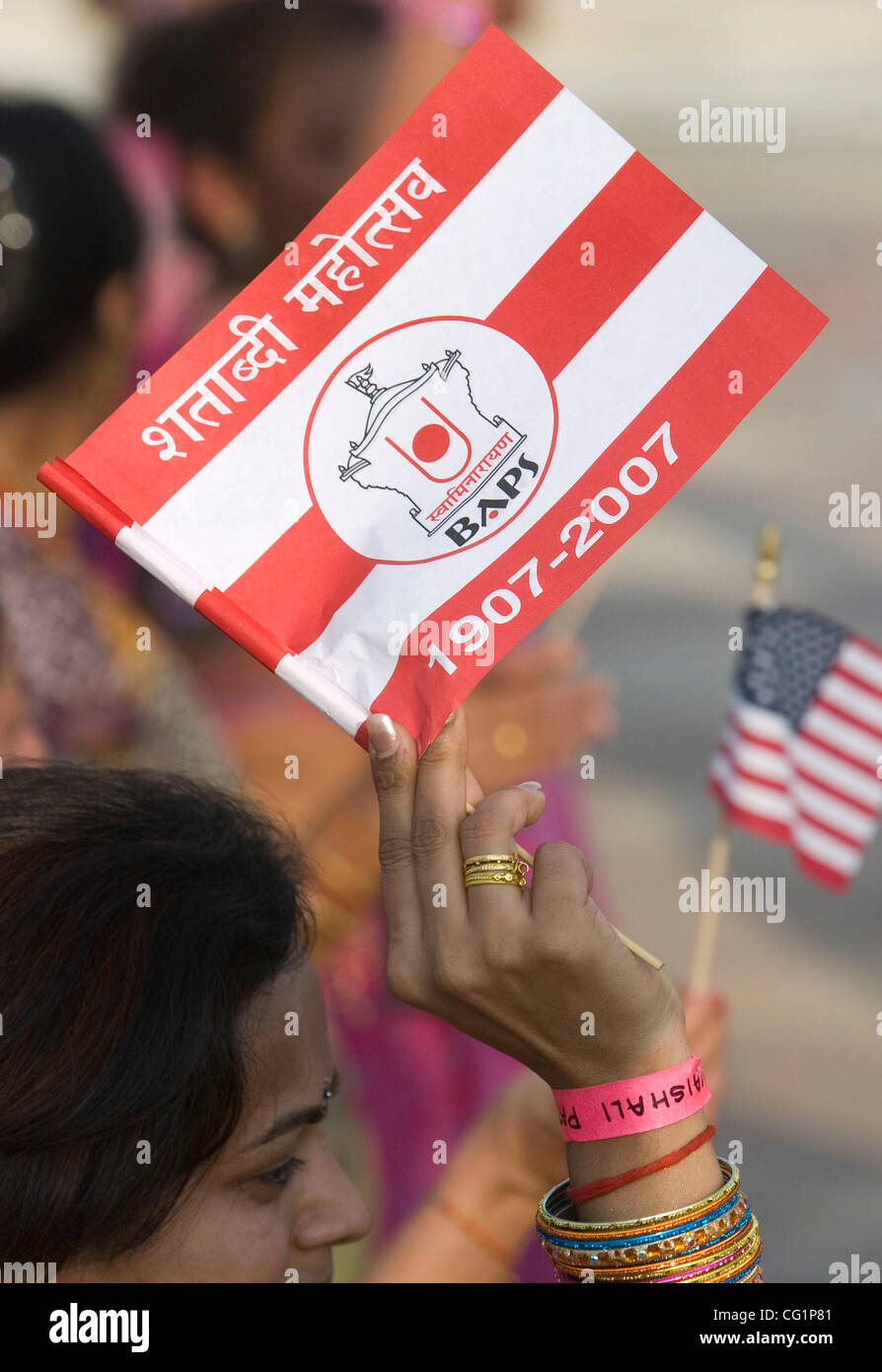 A woman holds a celebratory flag during dedication ceremonies of the ...