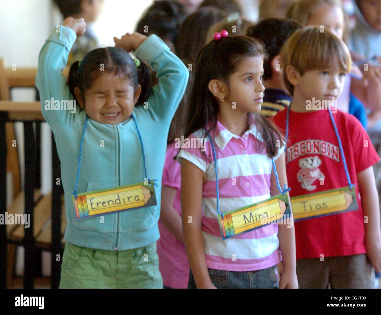 Kidergartner Erendira Camasco, left, with a big stretch and yawn as she ...