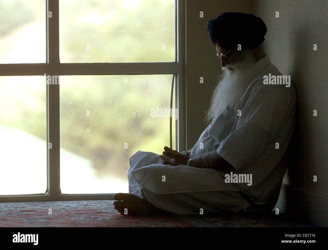 Religious worker Gurdev Singh prepares for the evening prayer at the ...