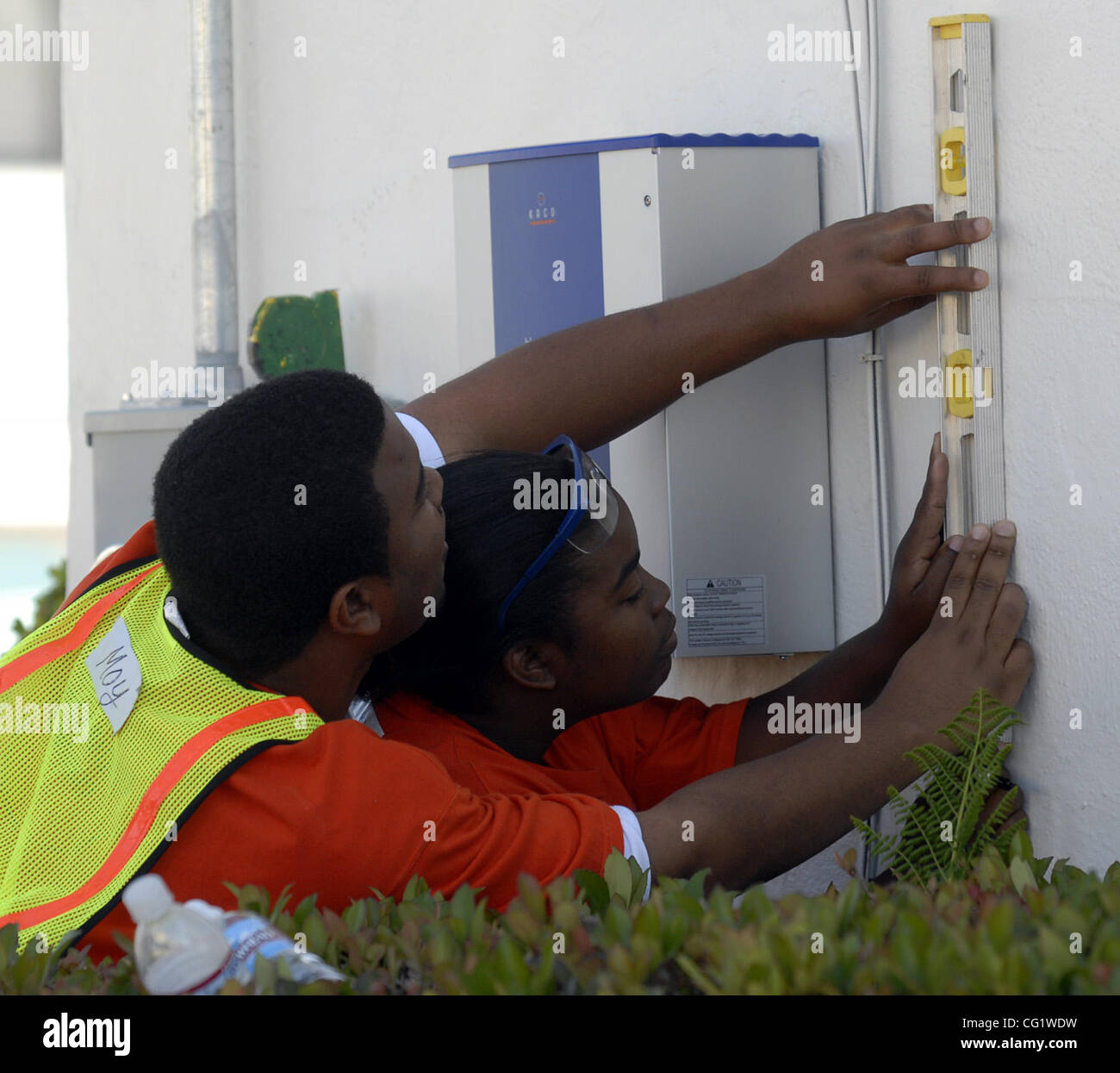 William Moy Jr. and Keyana Young measure out where an electrical box is ...
