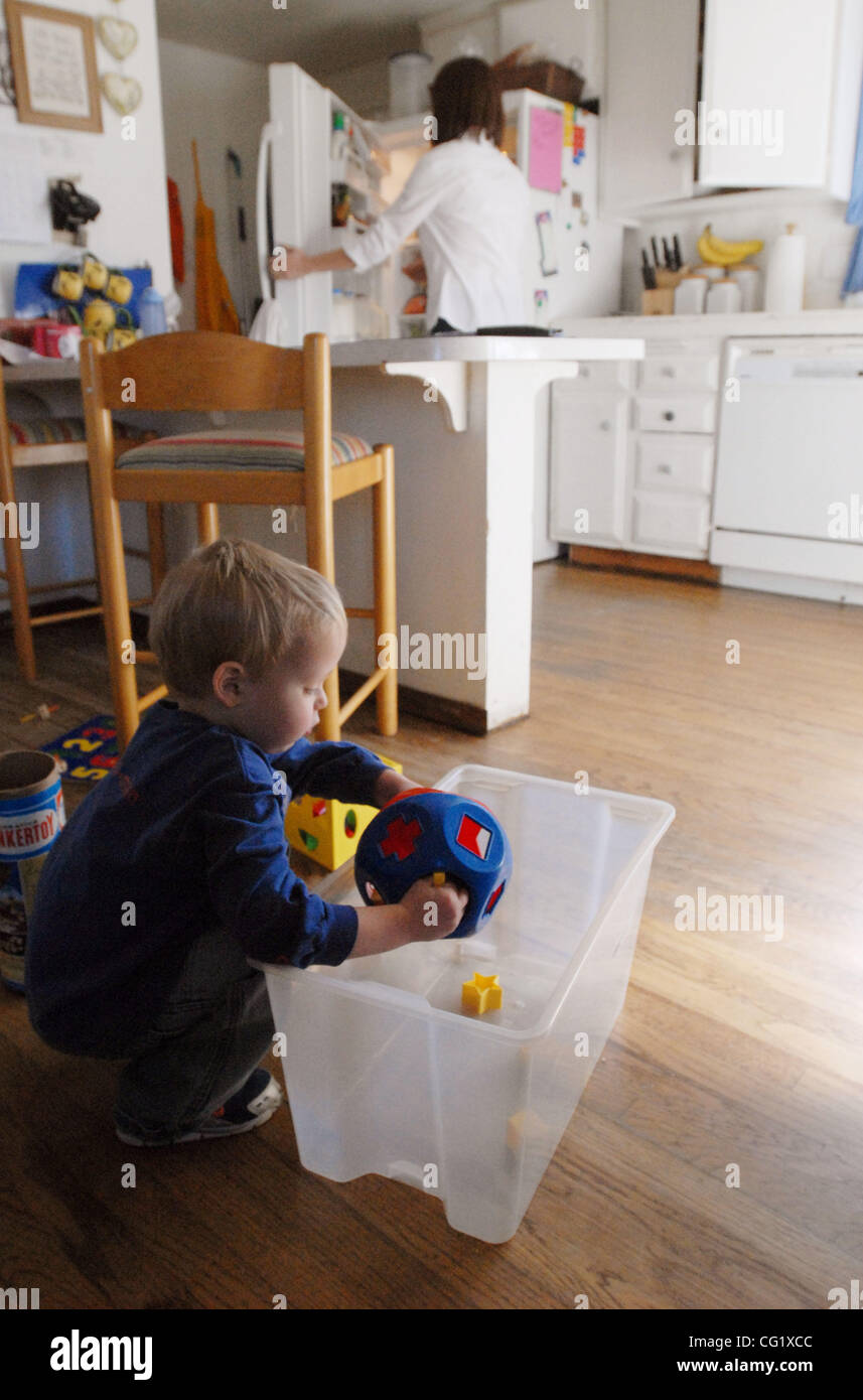 Four year-old Noah Holt plays with his toys as his mom, Cathy prepares ...