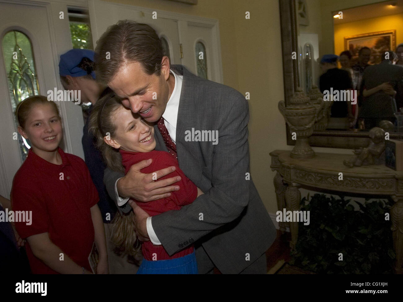 Hannah Blake (cq), 11, gets a big hug from Republican Eric Egland, a ...