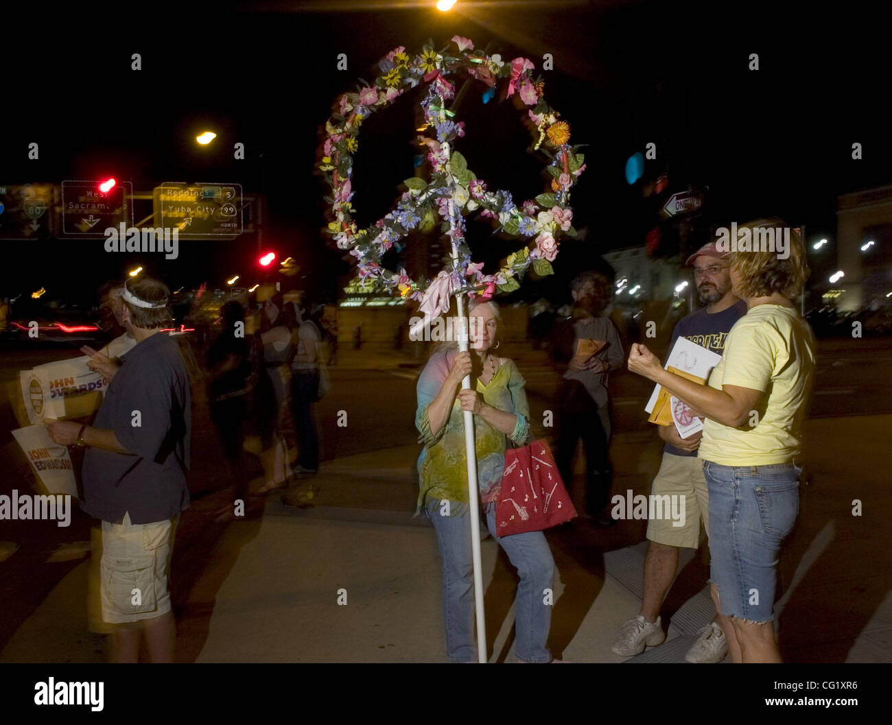 Candy Anderson (cq), holding peace sign, gathered with a small group to ...