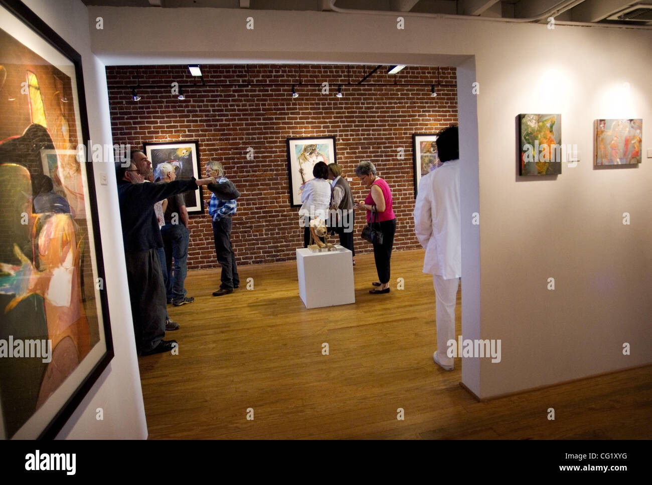 People enjoy looking at artwork at the b. sakata garo art gallery ...