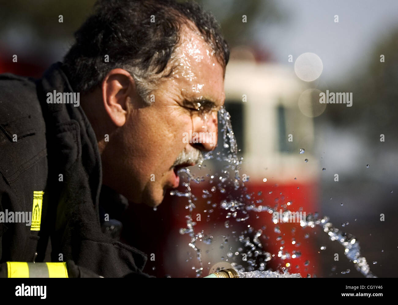 Captain Alex Macias, of Sacramento City Fire Department, cools off with ...