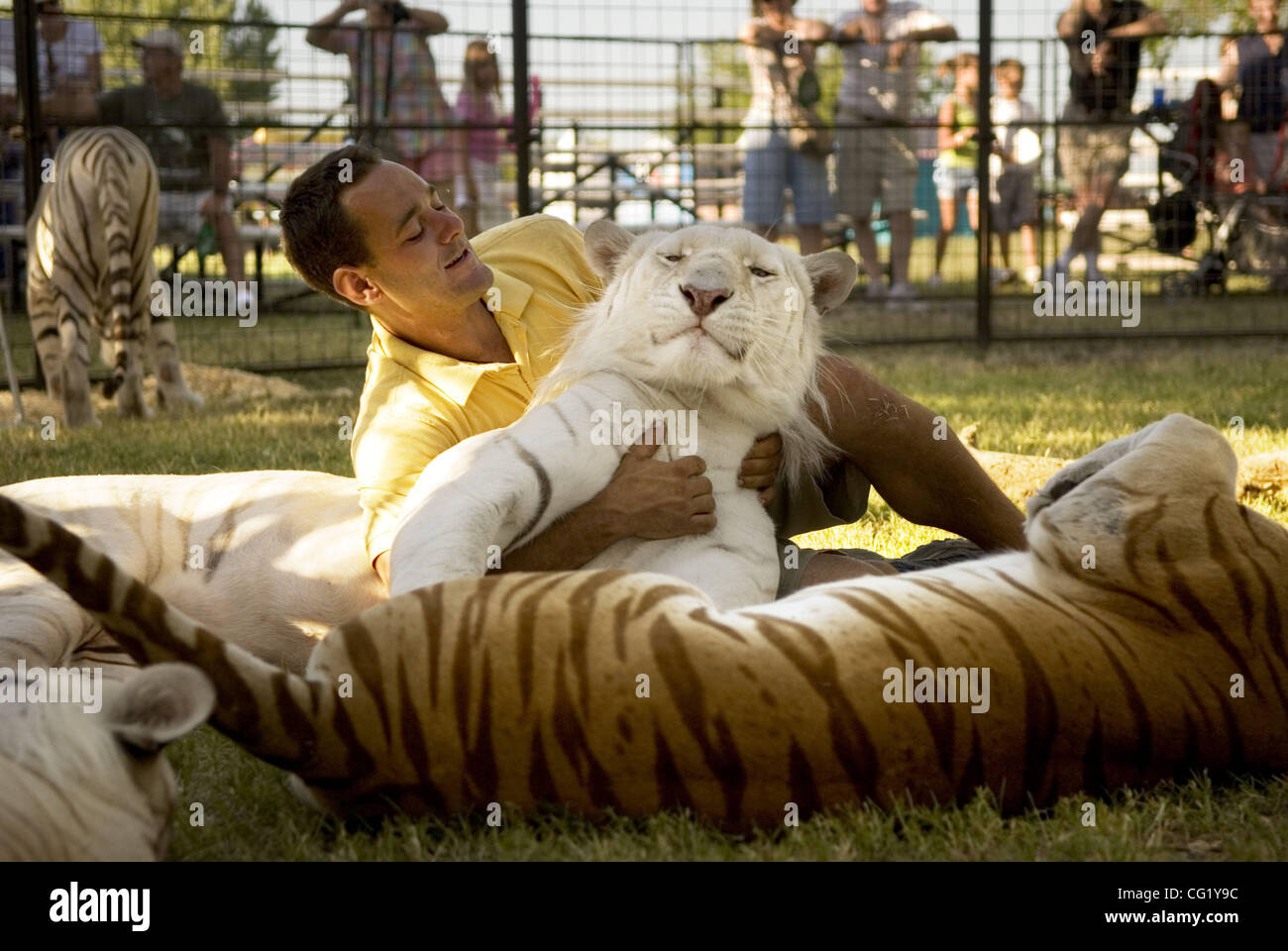 METRO SECONDARY Senior trainer Andy Spolyar cuddles a snow white bengal ...