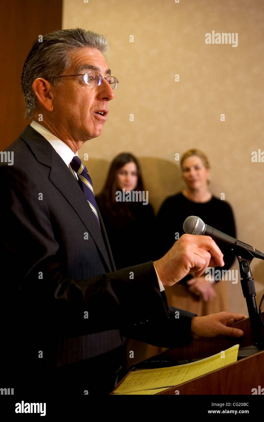 California State Treasurer Phil Angelides talks as his daughter Megan ...