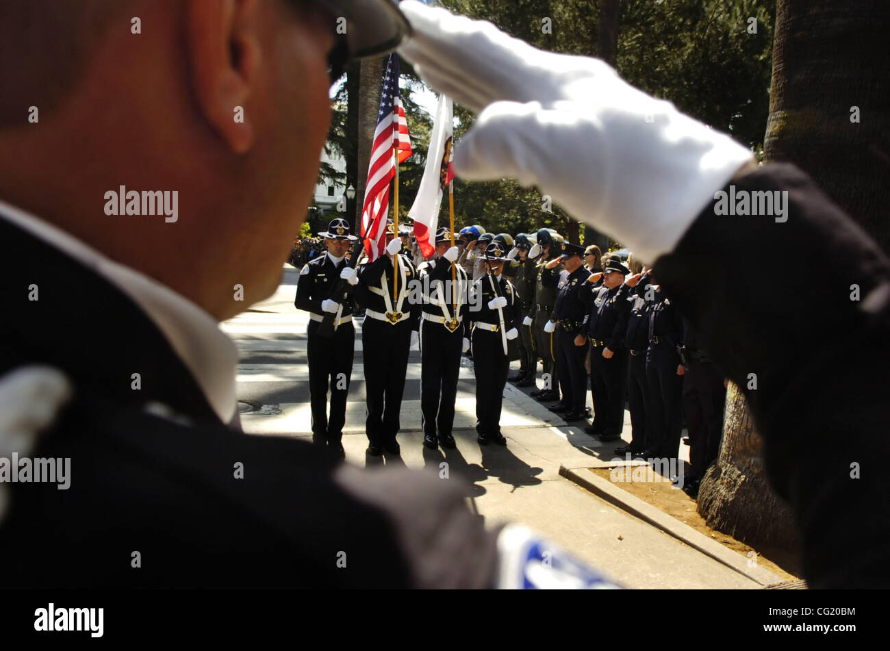 A police officer salutes the honor guard as it arrives at the 2007 ...