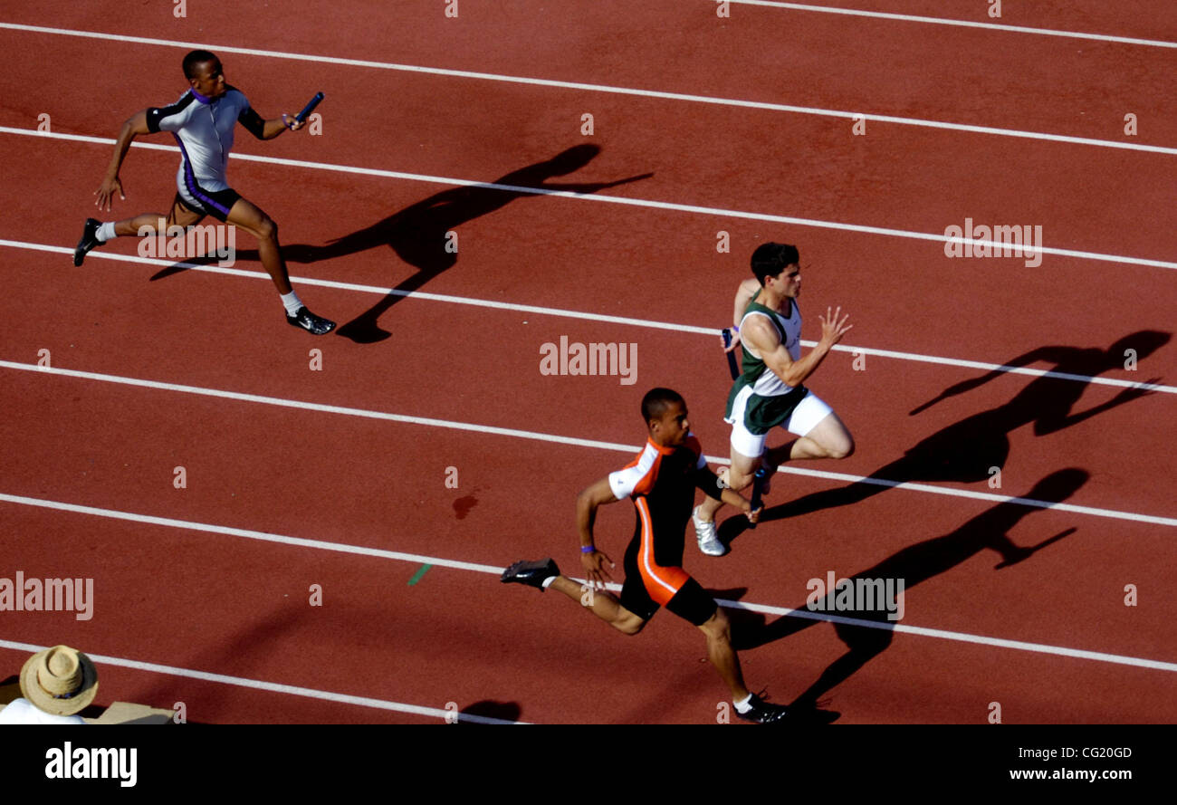 Runners in the 400 boys relay run their race during qualifying for the ...