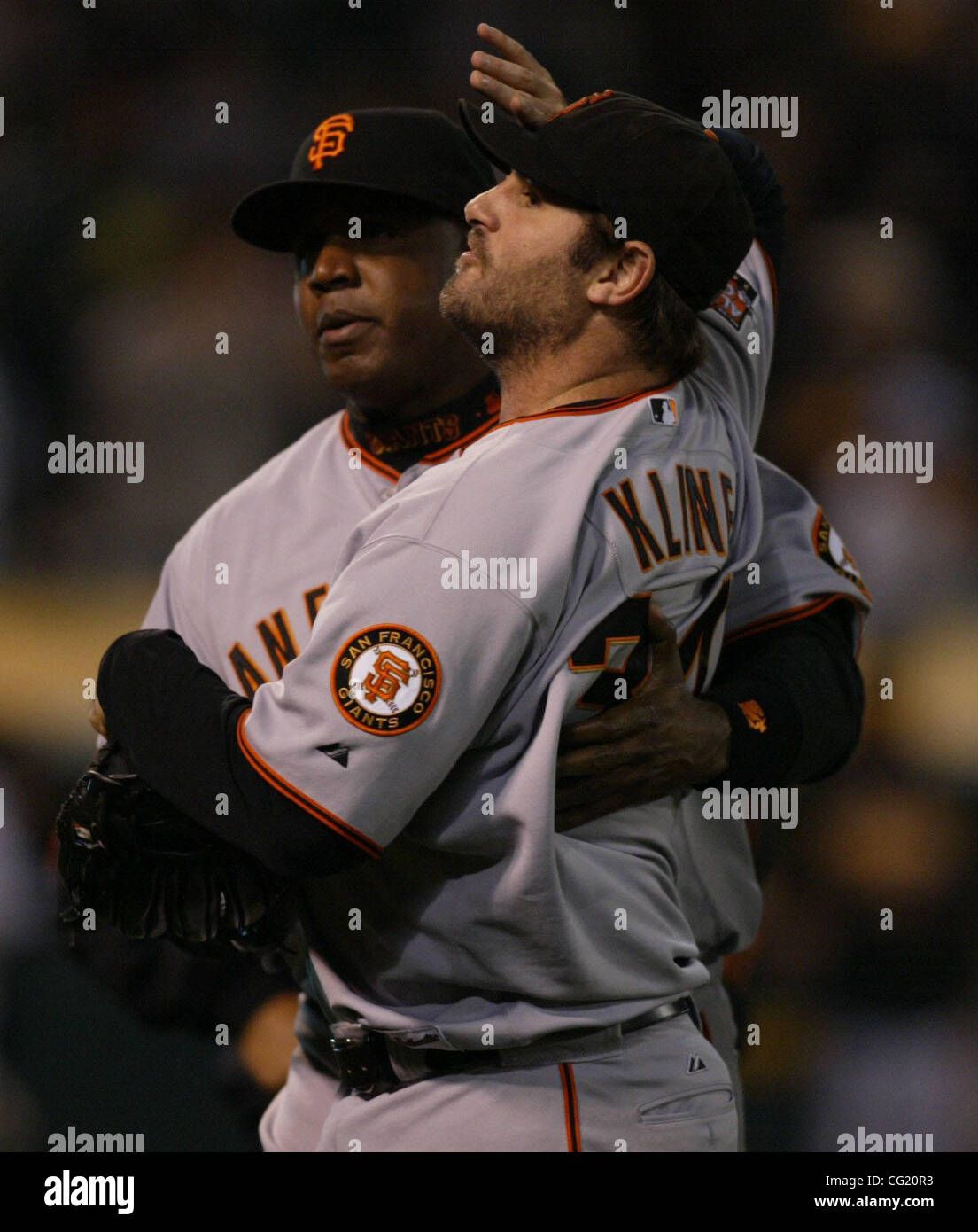 Barry Bonds holds back Steve Kline as he goes off at the umpire in 8th ...