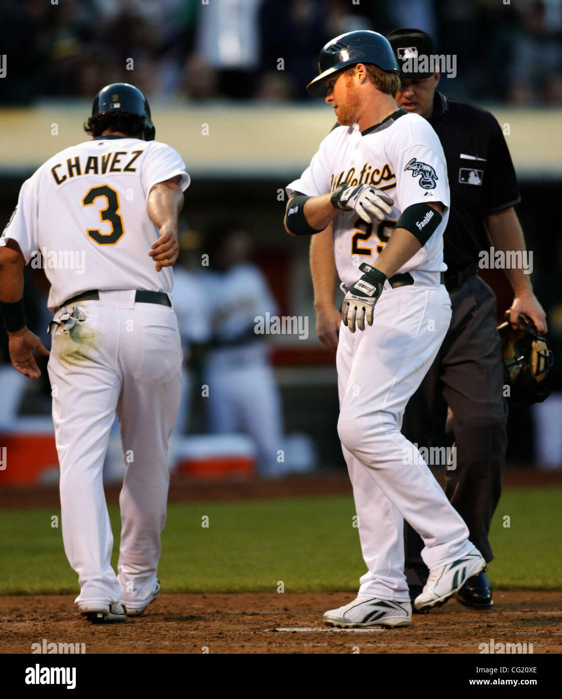A's slugger Dan Johnson crosses the plate and finishes slapping the ...