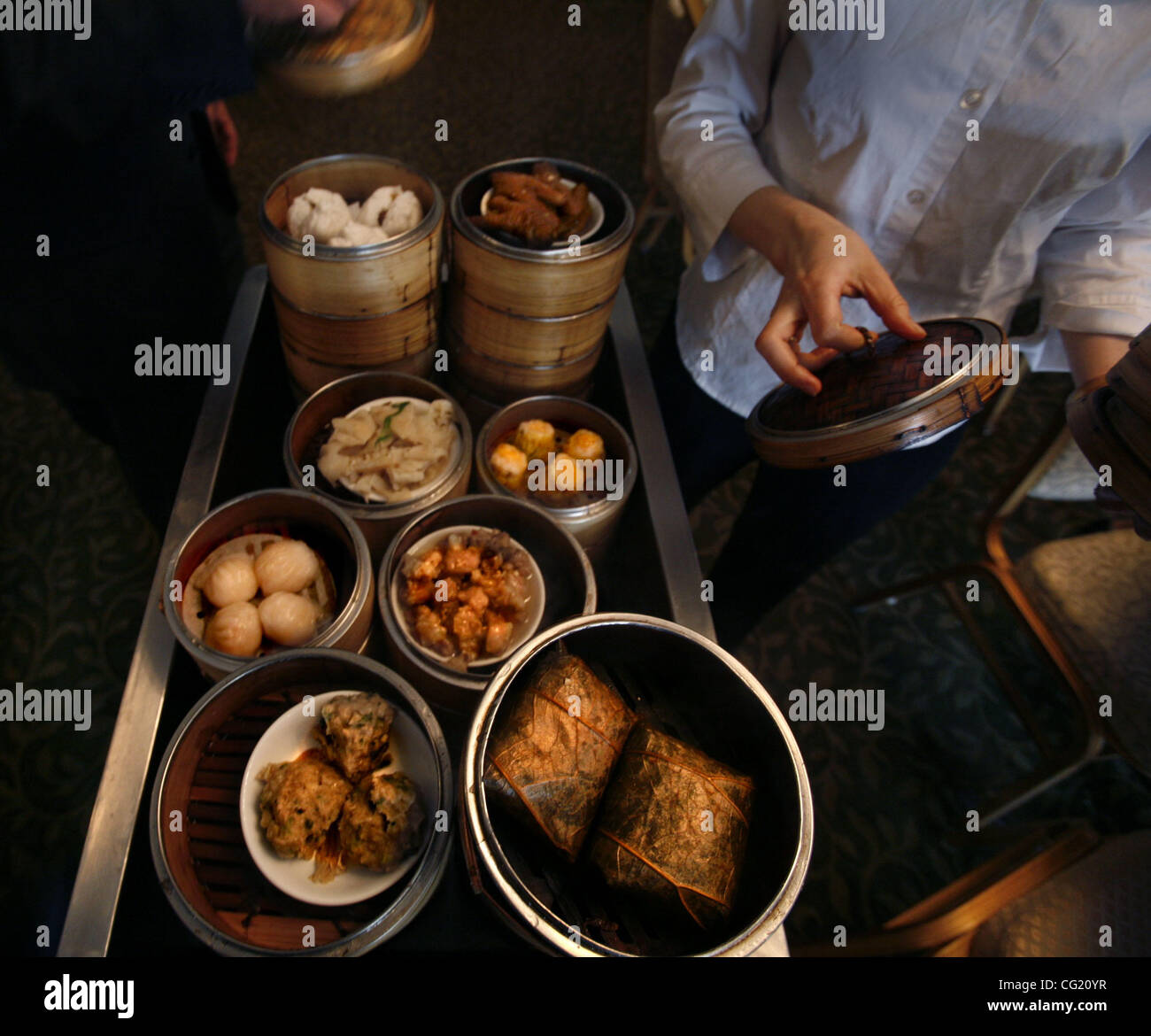 LEDE FOR COVER Hong Ma 32, the head "cart girl" displays her dim sum ...