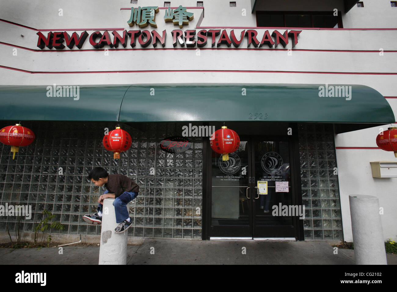 A child waiting for his family members plays outside the New Canton ...
