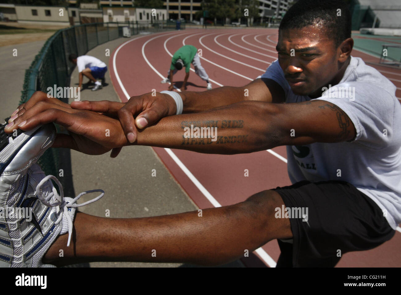 Jody Johnson (right) a sprinter for Sacramento State stretches of the ...