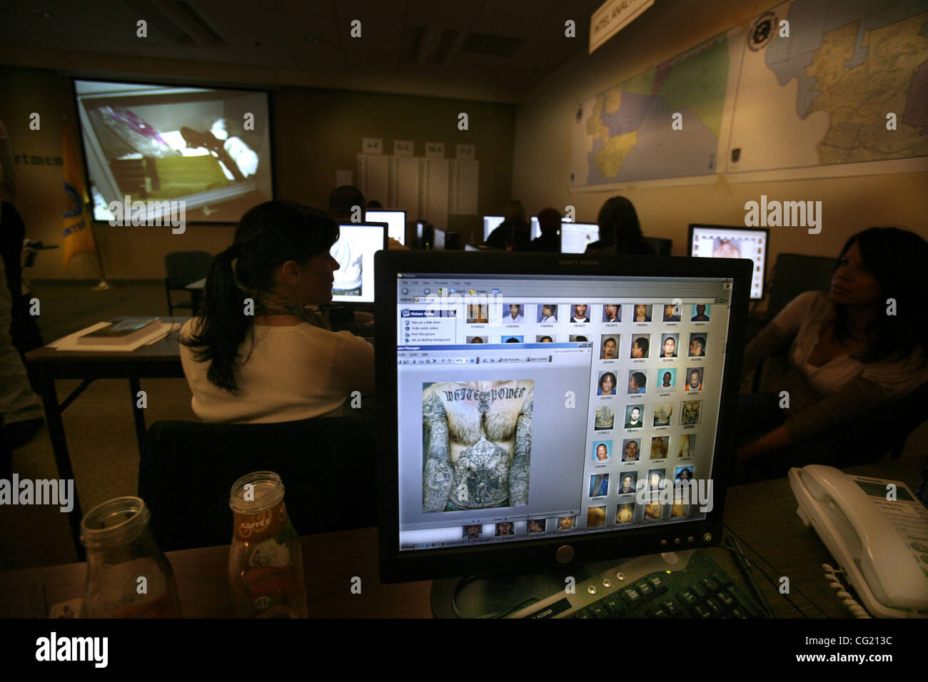 A computer screen full of gang members is display at the command center ...