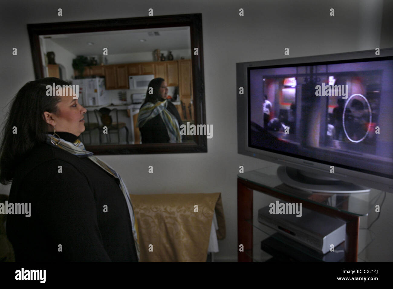 Lisa Joseph watches her television in her livingroom of a video she has ...