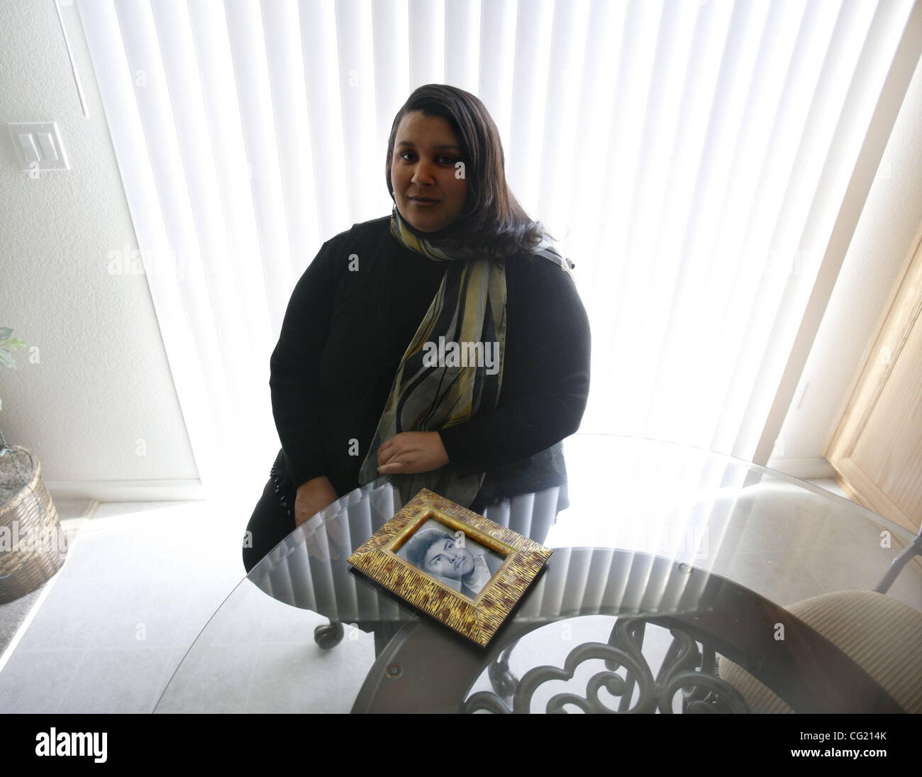 Lisa Joseph sits in her diningroom table with a picture of her uncle ...