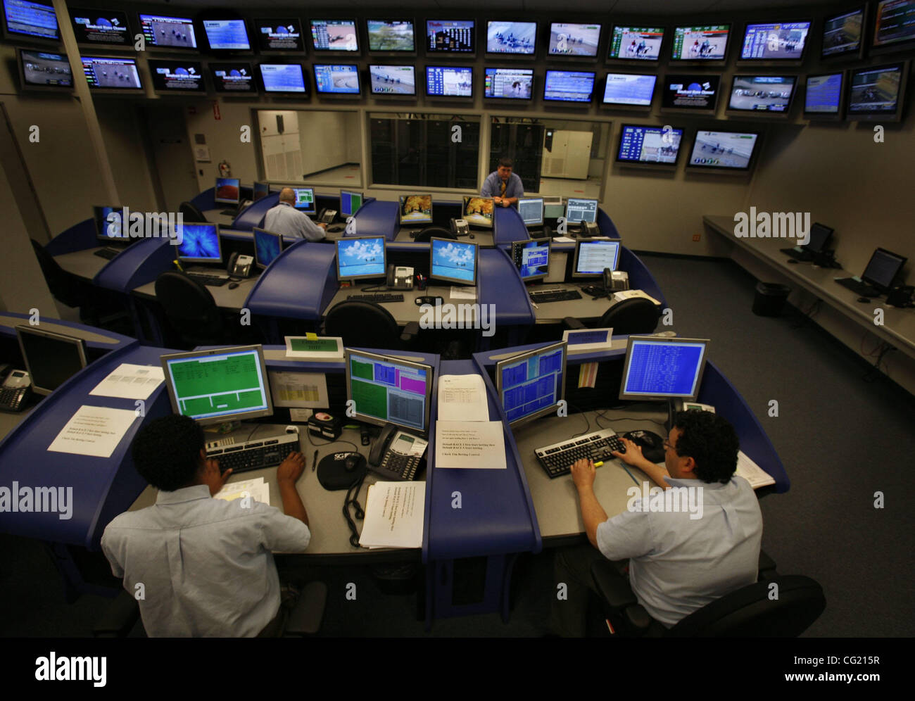 System operators work in the control room of Scientific Games-- the ...