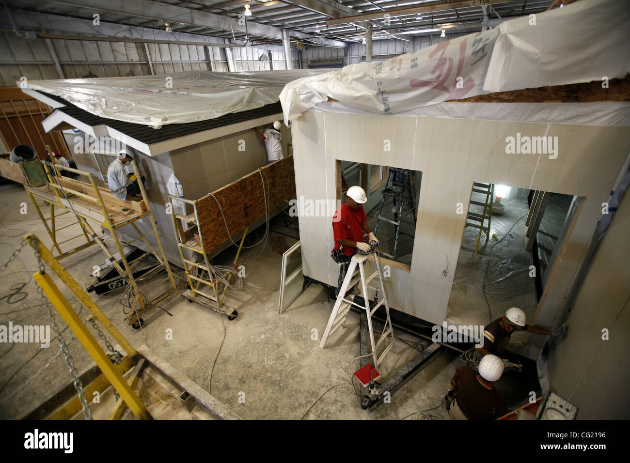 Workers construct a factory built homes at the Karsten Homes plant off ...