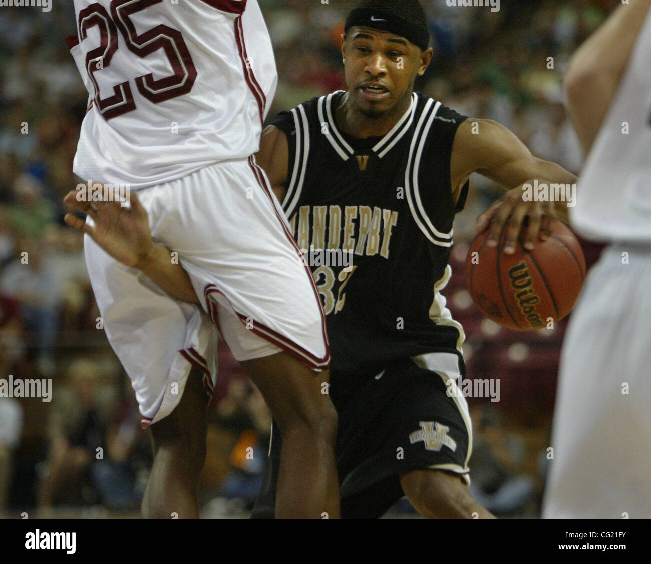 #32 for Vanderbilt Shan Foster drives the ball against #25 Kyle Weaver ...