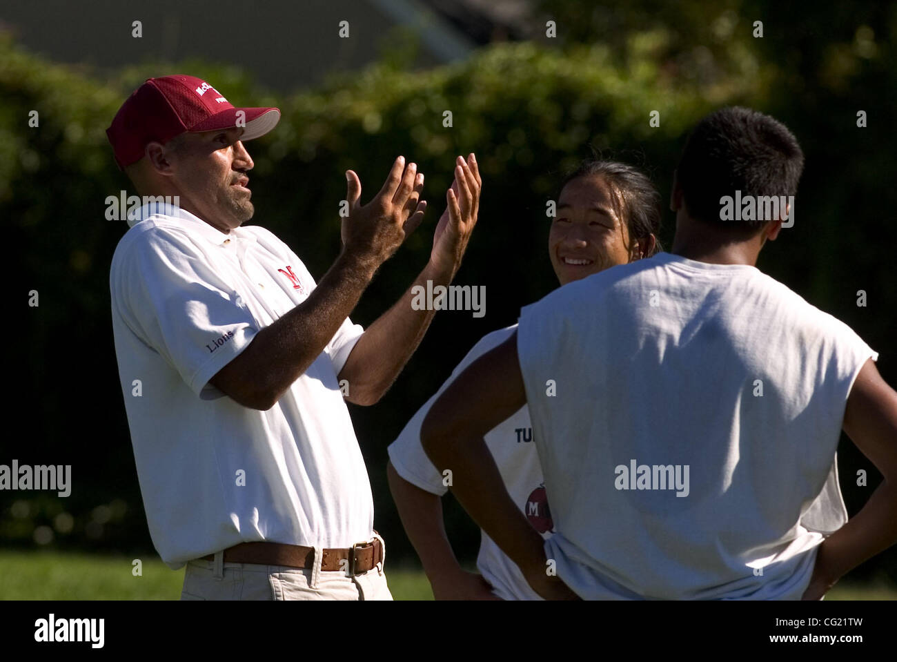 SECOND: McClatchy's head coach Chris Latino, left, teaches his kickoff ...