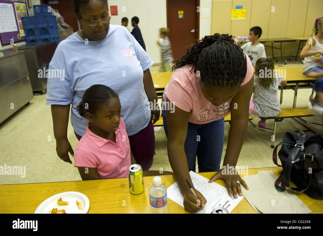 JUMP: Alyssa Williams, right, completes paperwork to join the Watch ...