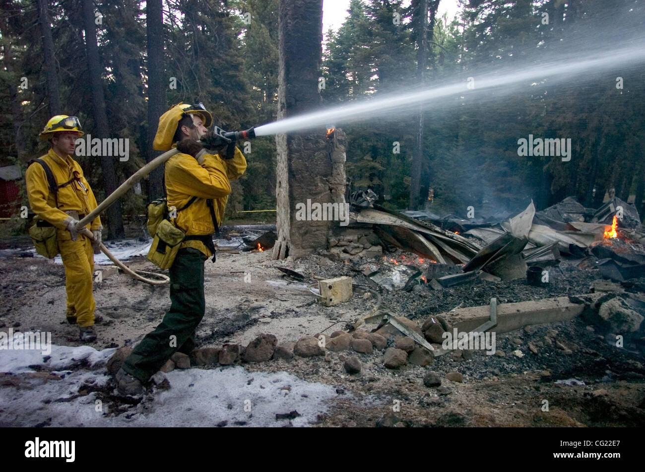 Firefighters Josh Rytter (cq) and Travis Smith (with hose) fight the ...
